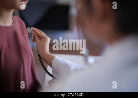 Asian psychologist women use stethoscope to examining heartbeat of ...