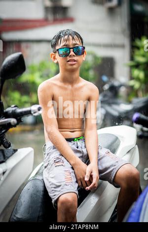 A cool little Filipino boy strikes a cool pose with his shades on in ...