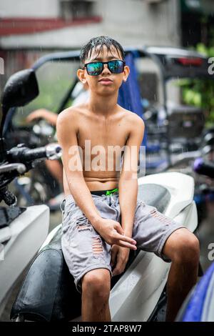 A cool little Filipino boy strikes a cool pose with his shades on in ...