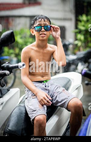A cool little Filipino boy strikes a cool pose with his shades on in ...