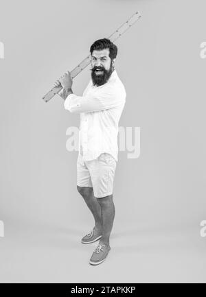 aggressive man with measuring ruler in studio. man with measuring ruler ...