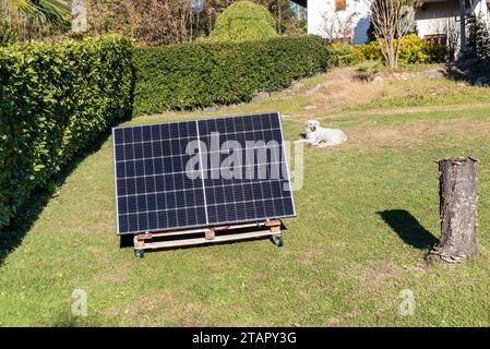 Photovoltaic panels on the wooden pallet in the home garden. Green ...