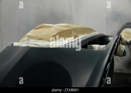 The photograph captures the scene of an automotive workshop, showcasing ...