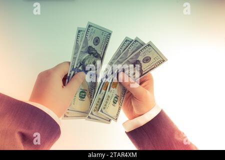 Businessman holding US dollar banknote money on white background Stock ...