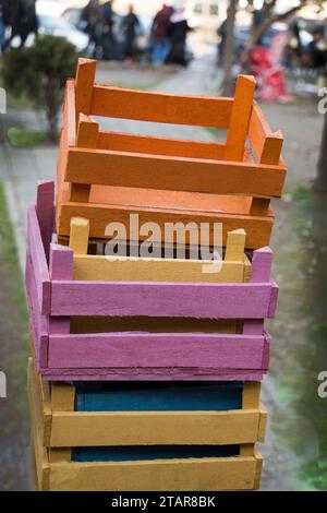 Colorful wooden empty crate boxes in hand for sale Stock Photo - Alamy