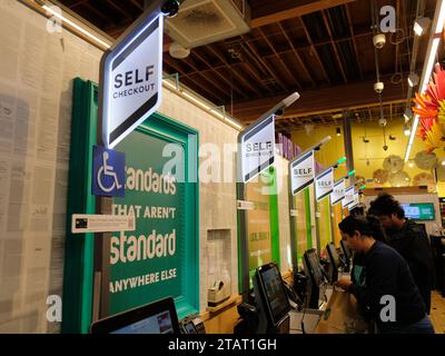 Row of automated self-checkout bays at a Whole Foods grocery store in ...