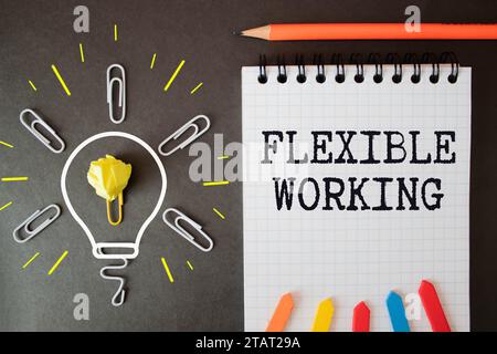 Flexible working policy concept. text on a torn page. red paper clip ...