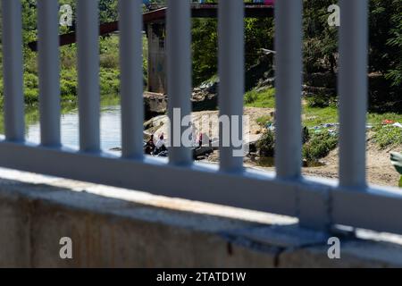 Haitians wash their clothes on the Haitian side of the Massacre River ...