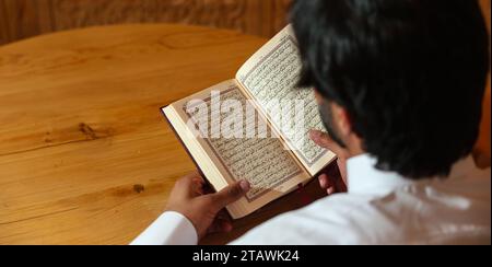 Hand holding the Holy Quran, guidance of life concept Stock Photo - Alamy
