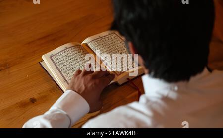 Hand holding the Holy Quran, guidance of life concept Stock Photo - Alamy