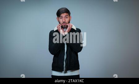 Scared man against dark background, Portrait of a young frightened man ...