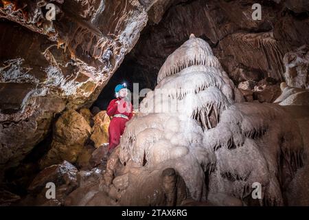 Female caver admiring cave formations, Somerset, Mendip, UK Stock Photo ...