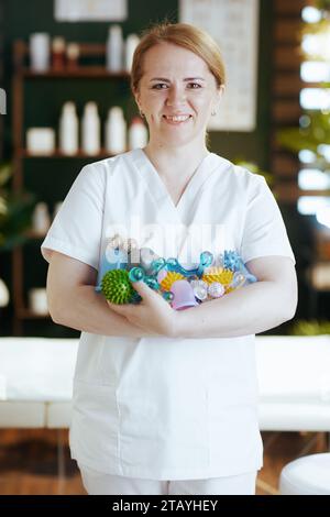 Healthcare time. happy massage therapist woman in massage cabinet with ...