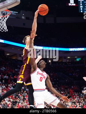 Minnesota forward Parker Fox (23) hangs on the rim after a dunk during ...