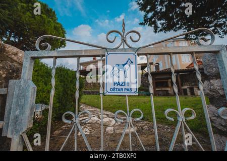 Sign reading "watch out, dangerous dog" written in croatian language ...