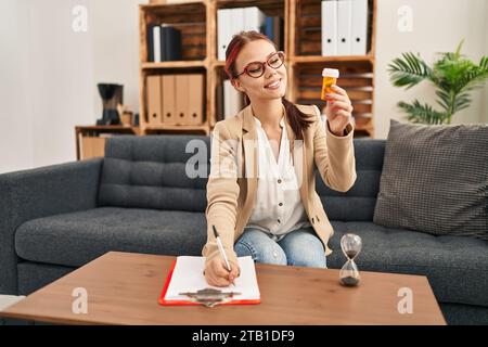 Young caucasian woman psychologist prescribe pills treatment at ...