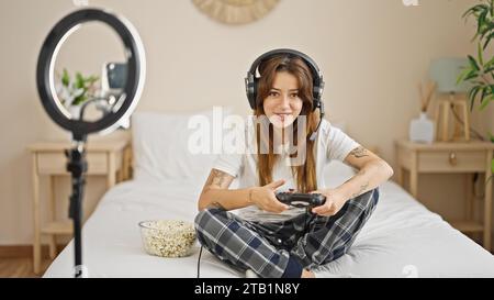 Young beautiful hispanic woman streamer tired using computer at gaming ...