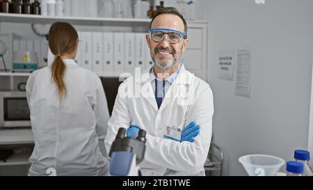 Two amiable scientists, best mates, sitting with arms crossed ...