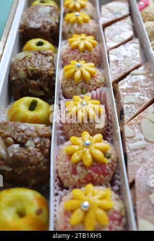 Indian assorted Diwali sweets or mithai with diya and flowers. Festive ...