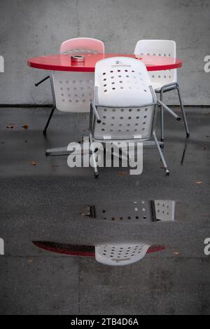 Reflection of a chair in the puddle Stock Photo - Alamy
