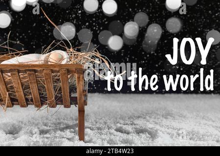 Manger with dummy of baby on dark wooden background with space for text ...