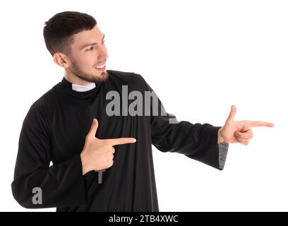 Young priest pointing at something on white background Stock Photo - Alamy