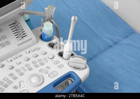 Ultrasound control panel and examination table in hospital, closeup ...