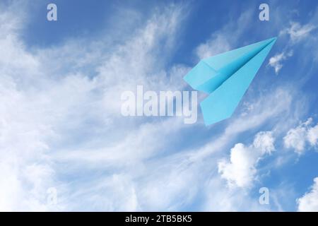 Light blue paper plane flying in sky with clouds with clouds Stock ...