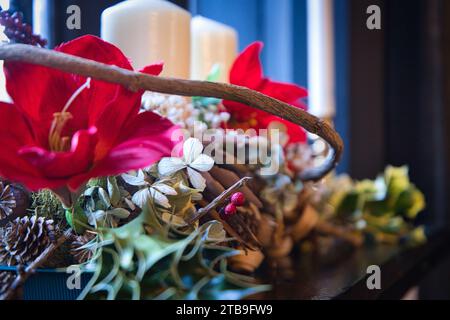Silver, gold, and red baubles and string lights decorate a Christmas ...