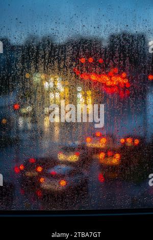 Rainy weather, road traffic, raindrops on a window pane, behind ...