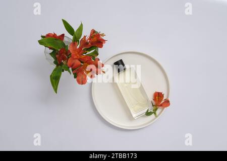 Unbranded round glass perfume bottle on golden podium on ivory ...