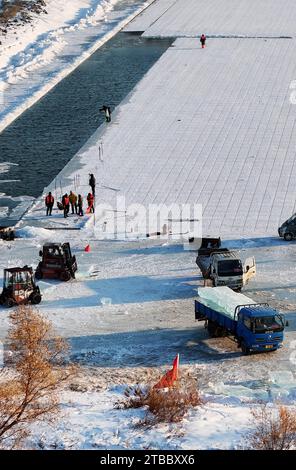 Aerial photo shows workers cutting ice lines to mine ice on Songhua ...