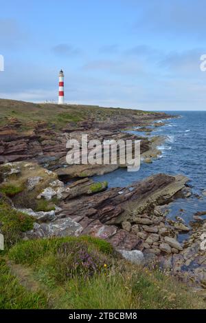 Tarbat Ness Lighthouse dominates the rocky coastline. Originally built ...