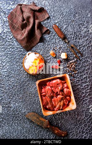 Raw chicken liver on stone background. Fresh ingredients ready for ...