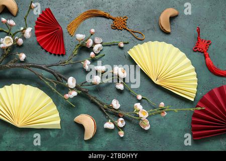 Composition with Chinese symbols, blooming sakura branch and tangerines ...