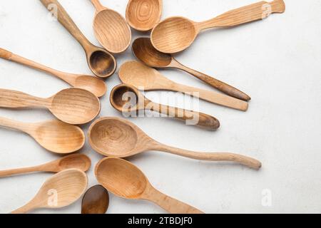 Different stylish wooden spoons on light background Stock Photo - Alamy