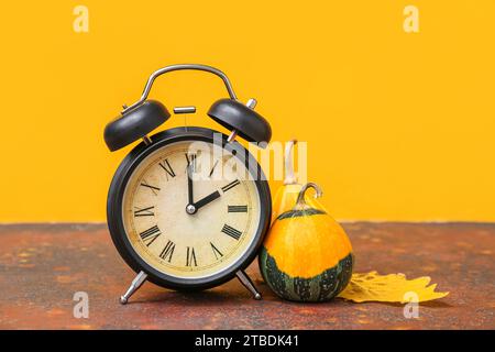 An alarm clock and pumpkins on black table Stock Photo - Alamy