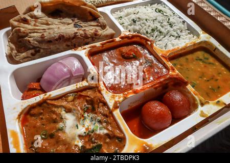 Punjabi thali in box. Indian lunch food parcel. Punjabi thaali of roti ...