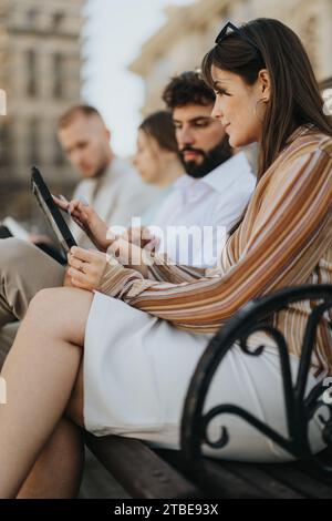 Dynamic business partners collaborating in an urban outdoor setting ...