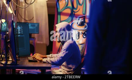 Hooded criminal welcoming new member in hacking group, showing him ...