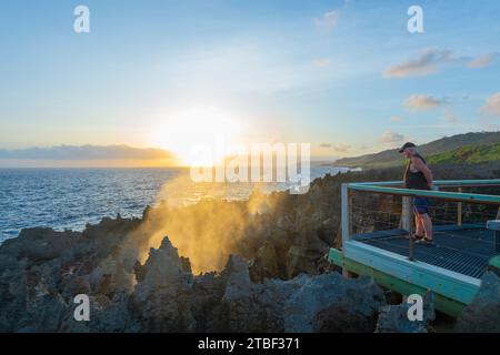 Backlit spray at sunset at the Blowholes, a population tourist ...