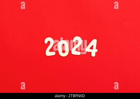 Wooden numbers 2024 on red background. Christmas, New Year, winter ...