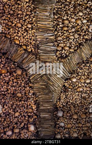Macabre sculptural design of a wall of bones and human skulls from The ...