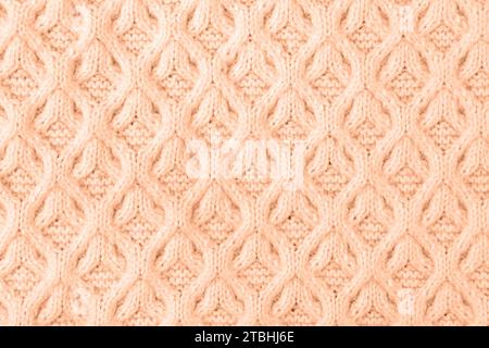 Demonstrating the colors of 2024 - Peach Fuzz. Knitted peach background ...