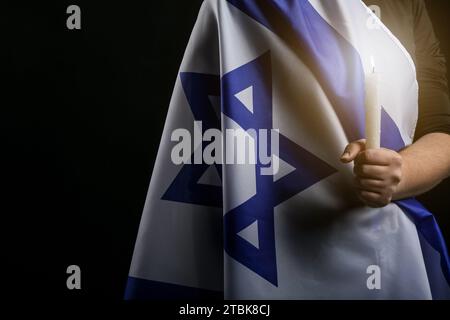 Jewish man with burning candle and flag of Israel honoring victims of ...