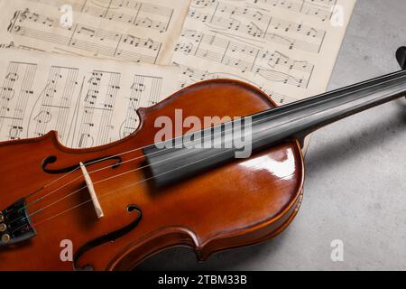Violin and music sheets on grey table, closeup Stock Photo - Alamy