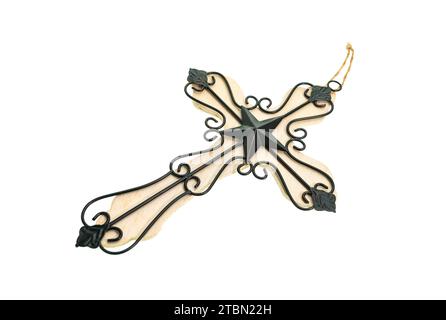 metal cross with scroll design hangs on wooden background Stock Photo ...