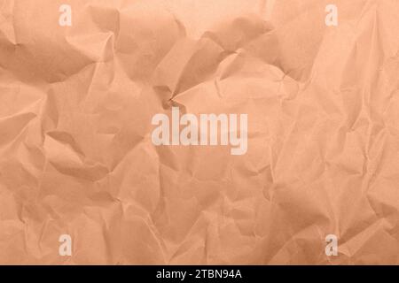 Crumpled paper Peach Fuzz color of the year 2024. Texture crumpled ...