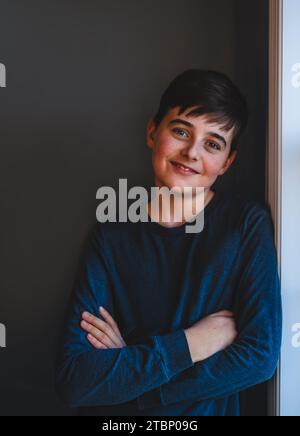 A pre-teen tween boy with his arms crossed with attitude standing near ...
