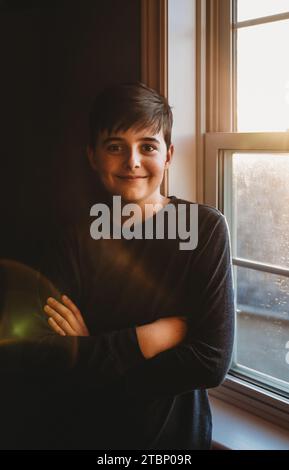 A pre-teen tween boy with his arms crossed with attitude standing near ...